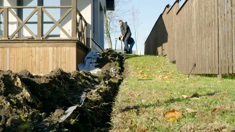 Two men digging a trench using shovels t... | Stock Video | Pond5