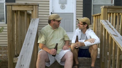 Two men sitting on porch steps talking, ... | Stock Video | Pond5