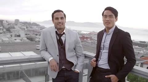 Two men stand on roof while wearing suit... | Stock Video | Pond5