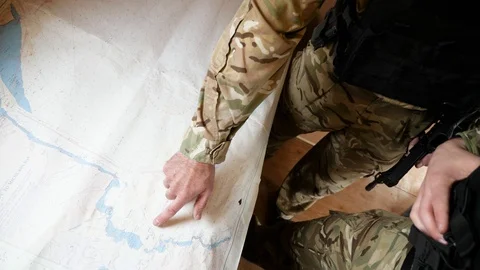 Two military men pointing on map with fi... | Stock Video | Pond5