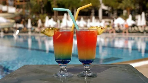 Two multi colored cocktail glasses with ... | Stock Video | Pond5