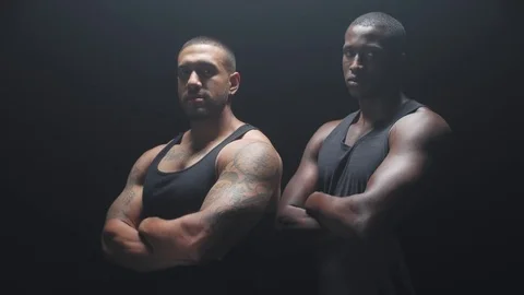 Two muscular men staring at the camera w... | Stock Video | Pond5