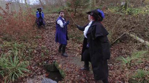 Two musketeers fencing in forest a third... | Stock Video | Pond5