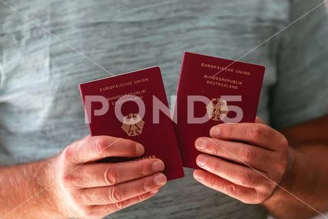 Two new German passports in the hands Stock Image #114498406