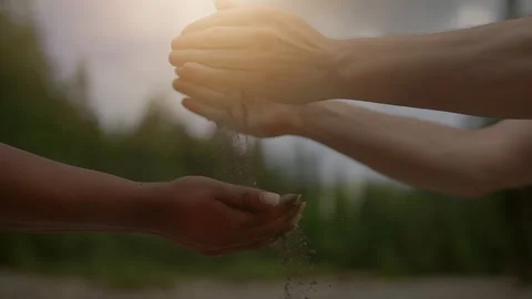 Two People Dropping Sand Into Each Other... | Stock Video | Pond5