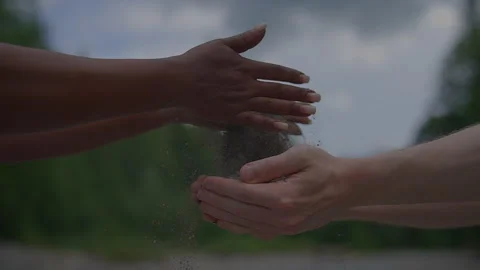Two People Dropping Sand Into Each Other... | Stock Video | Pond5