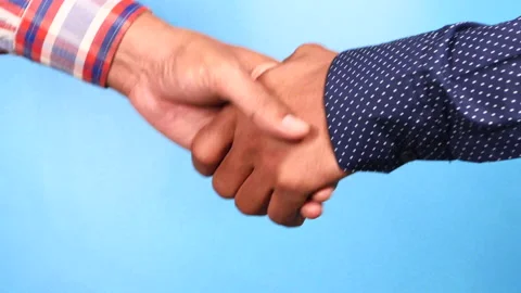 two people hand shake against blue backg... | Stock Video | Pond5