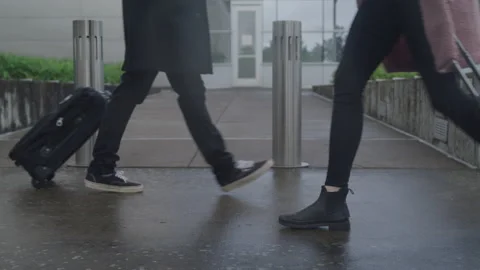 Two People with Luggage Walk Past Each O... | Stock Video | Pond5