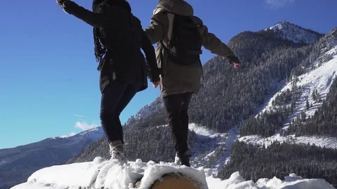 Two people walking and balancing on a sn... | Stock Video | Pond5