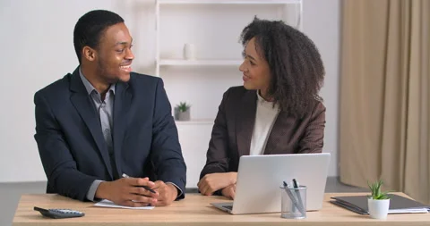 Two people work sitting at table give fi... | Stock Video | Pond5