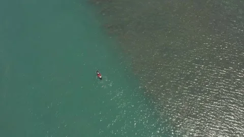 Two person floating in kayak near coral ... | Stock Video | Pond5