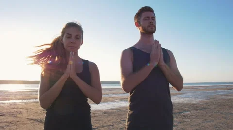 Two persons doing couple yoga namaste po... | Stock Video | Pond5