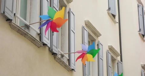 Two pinwheels stop spinning outside wind... | Stock Video | Pond5