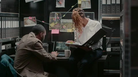 Two police officers looking at detective... | Stock Video | Pond5