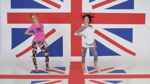 Two pretty girls are synchronically danc... | Stock Video | Pond5