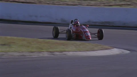 Two race cars pull out of a fast turn on... | Stock Video | Pond5