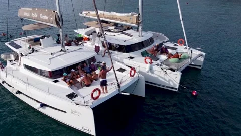 Two sailing catamarans together, tourist... | Stock Video | Pond5