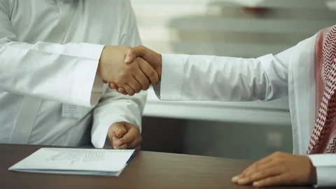 two saudi business men shaking hands- | Stock Video | Pond5