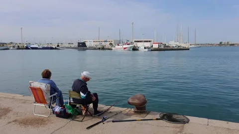 Two seniors enjoying time sitting on a c... | Stock Video | Pond5