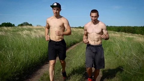 Two shirtless muscular men exer ising in... | Stock Video | Pond5
