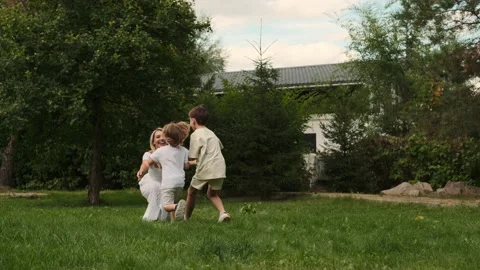 Two sons of different ages run to their ... | Stock Video | Pond5