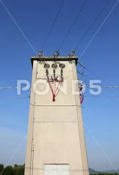 Two-storey high electrical substation with high voltage cables that ...