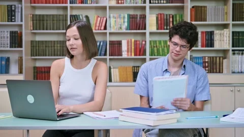 Two students sitting in college library,... | Stock Video | Pond5