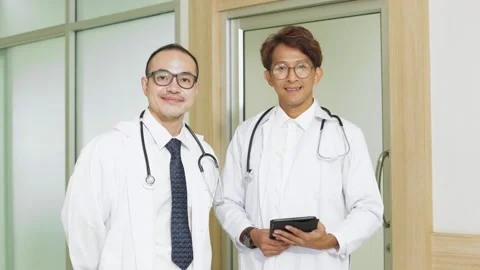 Two Successful Doctor Look at Camera an... | Stock Video | Pond5