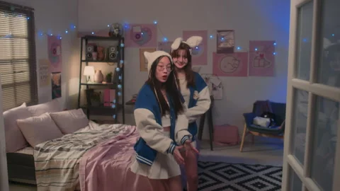 Two Teenage Girls in Matching Outfits Da... | Stock Video | Pond5