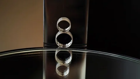 Two wedding rings on mirror background | Stock Video | Pond5