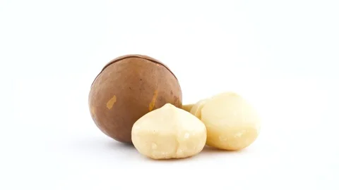 Two whole and one half macadamia nut ker... | Stock Video | Pond5