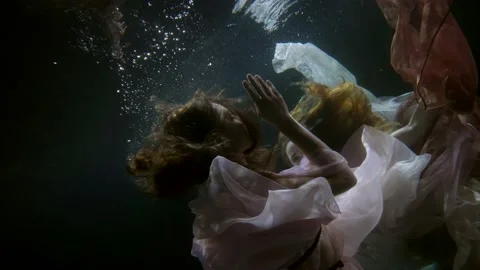 two women are floating in translucent fa... | Stock Video | Pond5
