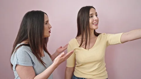 Two women arguing over isolated pink bac... | Stock Video | Pond5