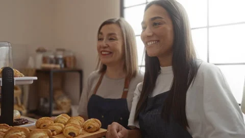 Two women bakers smiling and working tog... | Stock Video | Pond5