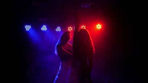Two women dancing around the pole by the... | Stock Video | Pond5