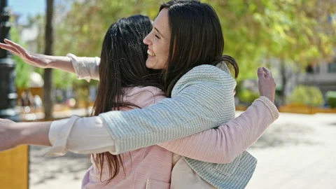 Two women hugging each other at park | Stock Video | Pond5