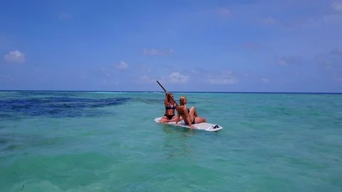 Two Women Paddling On Paddle Board, doll... | Stock Video | Pond5