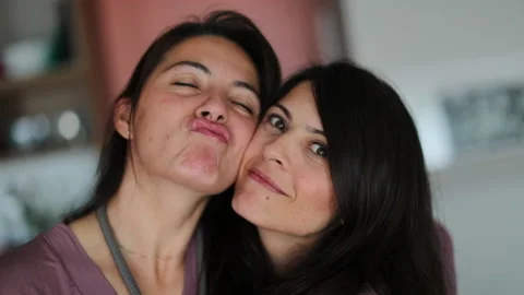 Two women posing together cheek to cheek... | Stock Video | Pond5