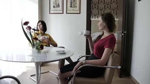 Two women sitting at a table in a hotel ... | Stock Video | Pond5