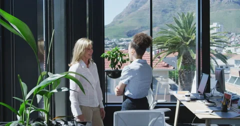 Two women talking near the window | Stock Video | Pond5