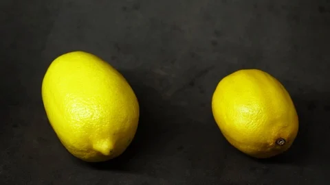 two yellow lemons on a black background.... | Stock Video | Pond5