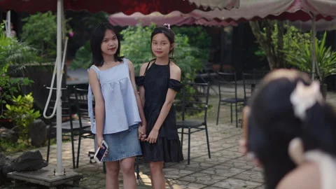 two young Asian teenage girls holding ha... | Stock Video | Pond5