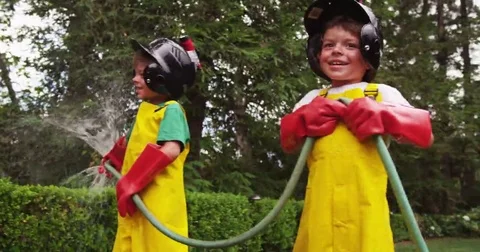 Two young brothers work together to cont... | Stock Video | Pond5