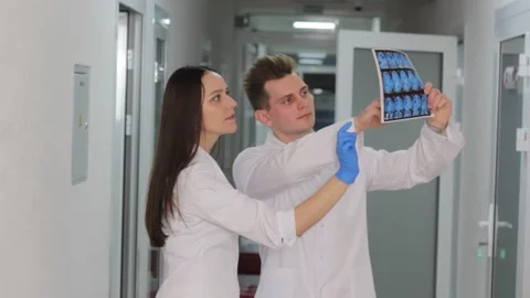 Two young doctors look at the result of ... | Stock Video | Pond5
