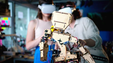 Two young engineers fixing a mechanical ... | Stock Video | Pond5