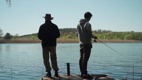 Two young men fishing from the pier. riv... | Stock Video | Pond5