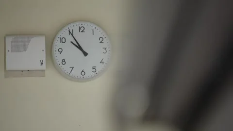 Typical school clock anchored on a wall. | Stock Video | Pond5