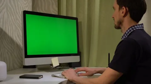 Typing on a keyboard in front of a monit... | Stock Video | Pond5