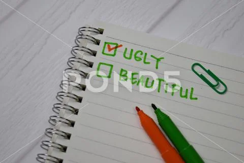Ugly and Beautiful write on a book. Supported by an additional services ...