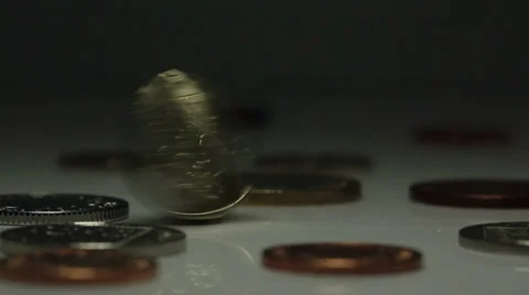 UK One Pound Coin spinning and falling i... | Stock Video | Pond5